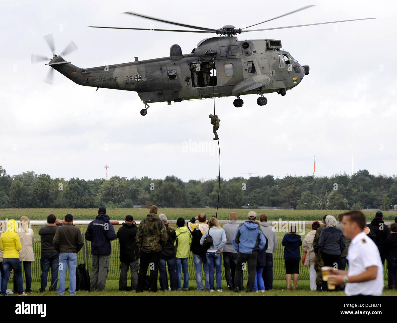 Visitors look at a demonstration by a type Seaking helicopter during ...