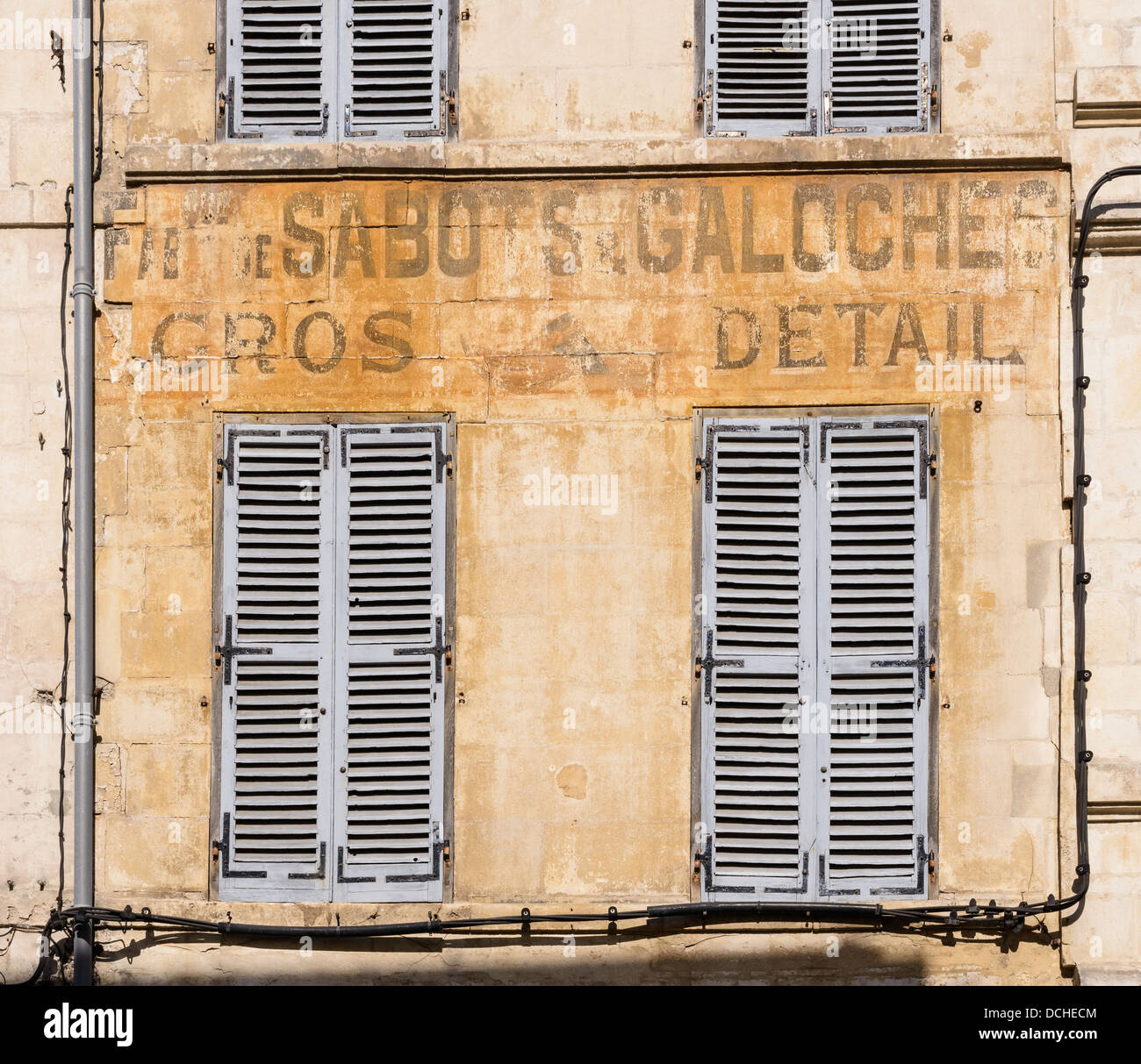 Shuttered windows and old sign painting on building La Rochelle ...