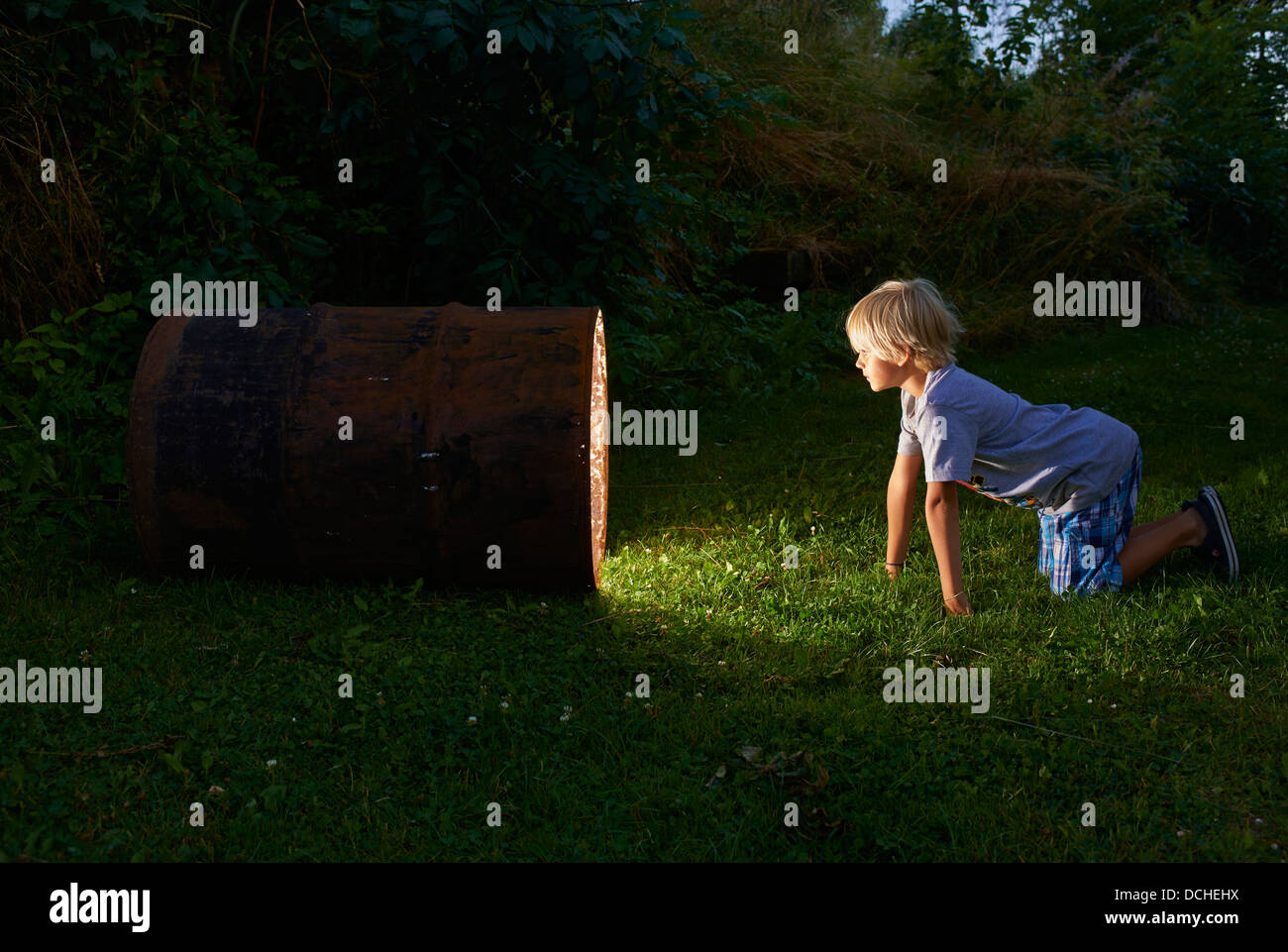 Child boy finds a treasure in magic barrel at dusk Stock Photo - Alamy