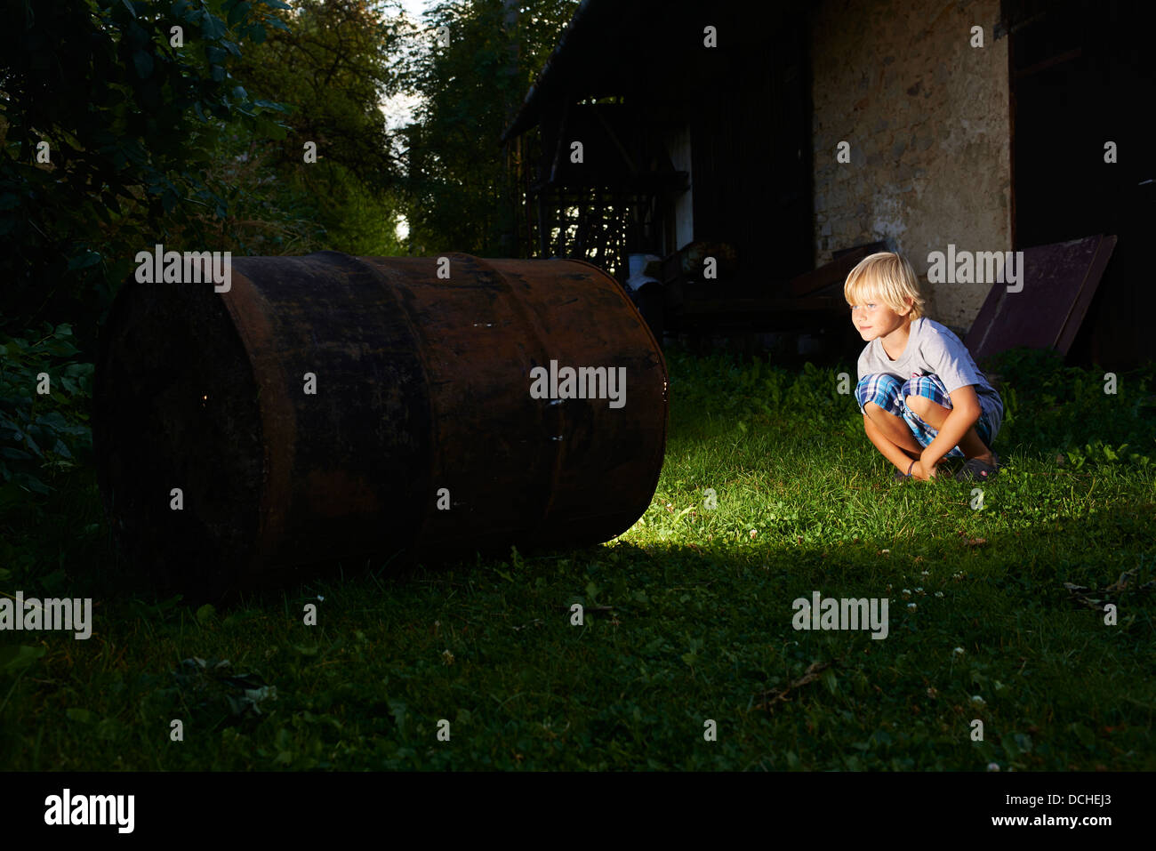 Child boy find a treasure in magic barrel at dusk Stock Photo - Alamy