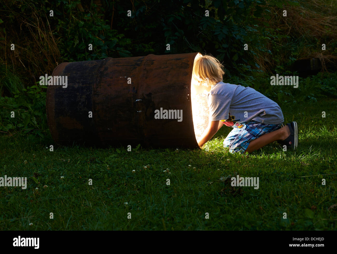 Child boy find a treasure in magic barrel at dusk Stock Photo - Alamy