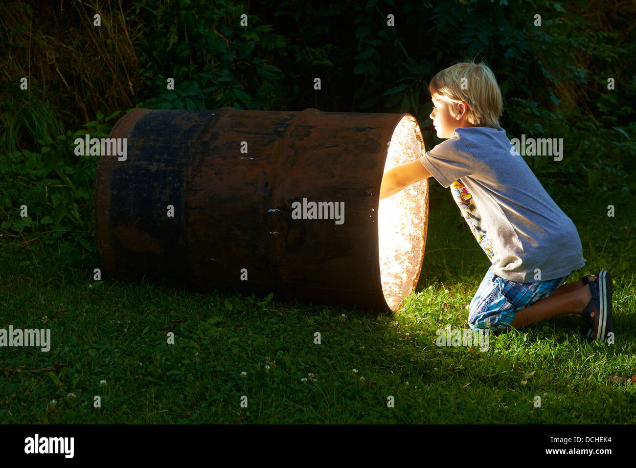 Child boy find a treasure in magic barrel at dusk Stock Photo - Alamy