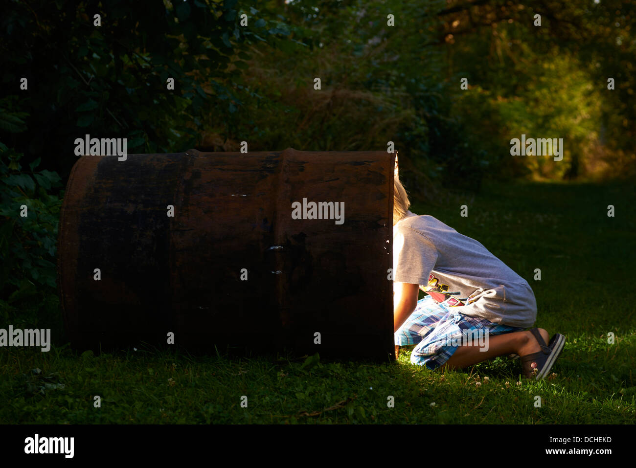 Child boy find a treasure in magic barrel at dusk Stock Photo - Alamy