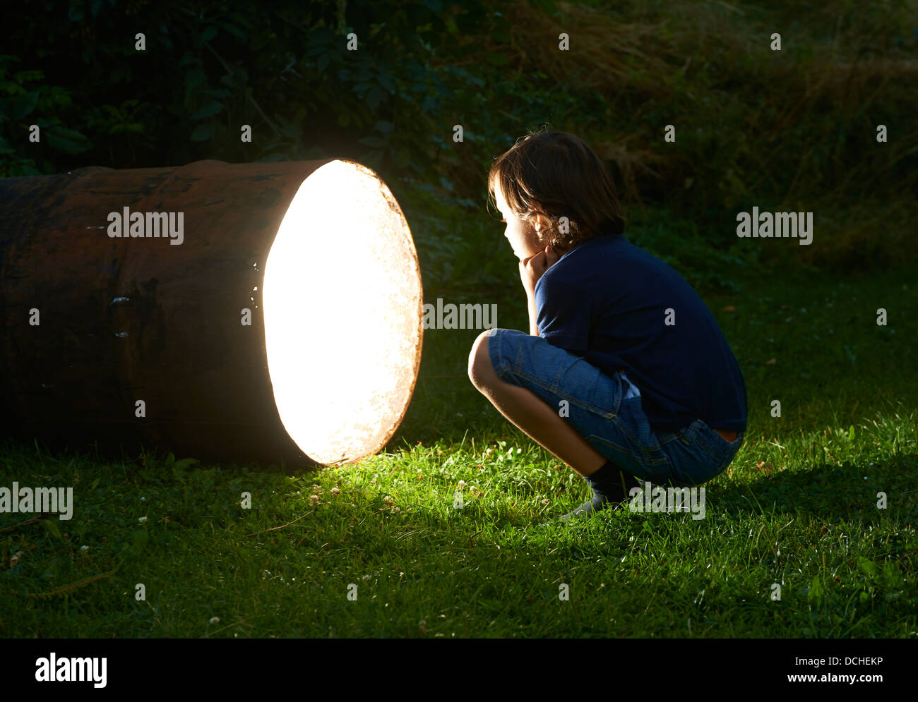 Child boy find a treasure in magic barrel at dusk Stock Photo - Alamy