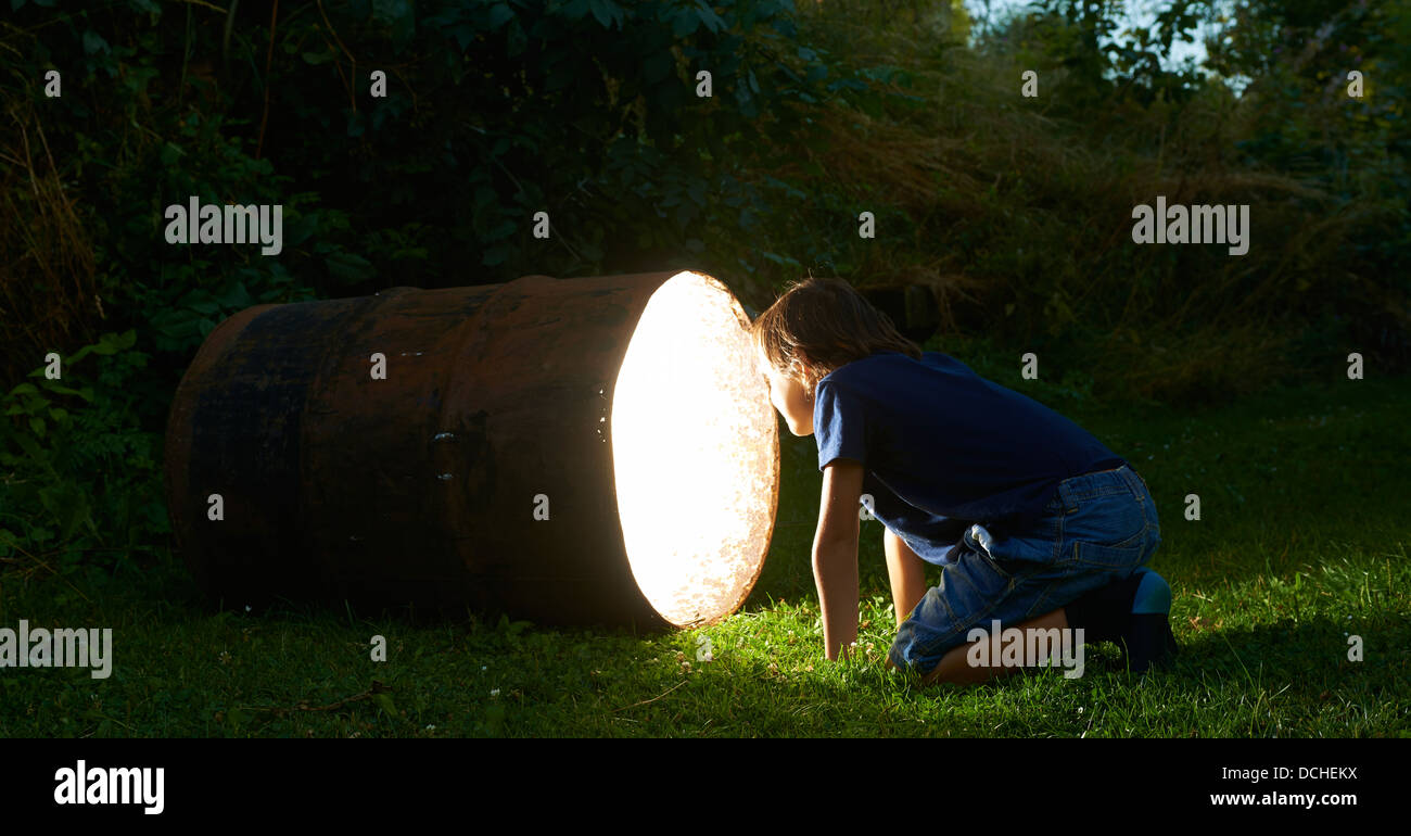 Child boy find a treasure in magic barrel at dusk Stock Photo - Alamy