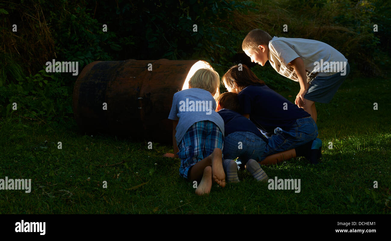 Child boy find a treasure in magic barrel at dusk Stock Photo - Alamy