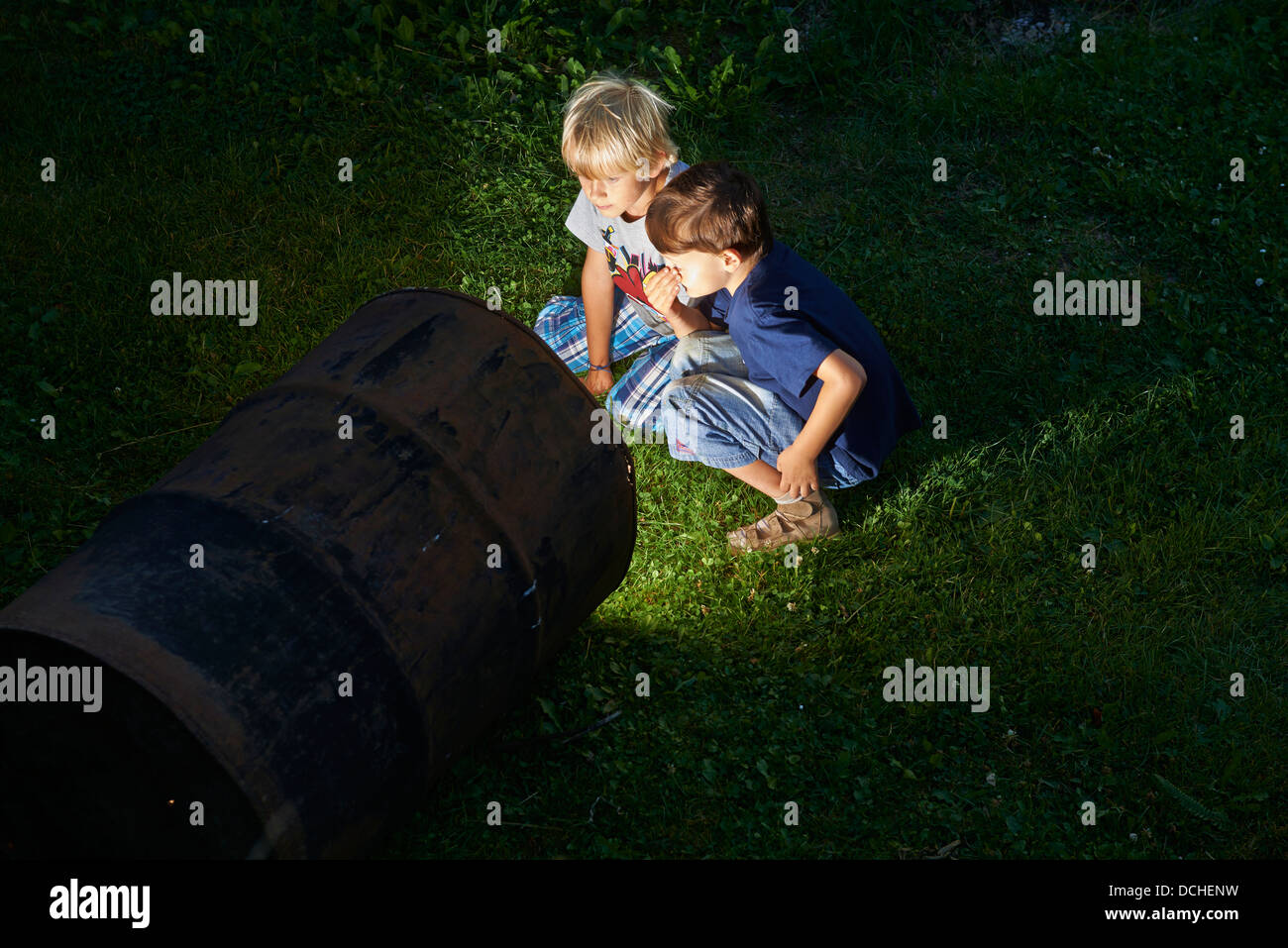 Child boy find a treasure in magic barrel at dusk Stock Photo - Alamy