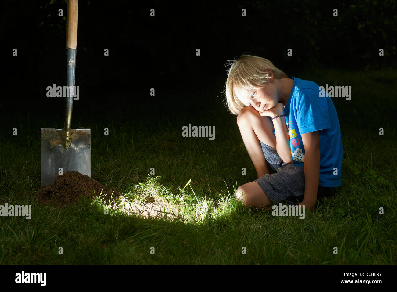 Child boy digging a treasure in magic hole in soil at dusk Stock Photo ...