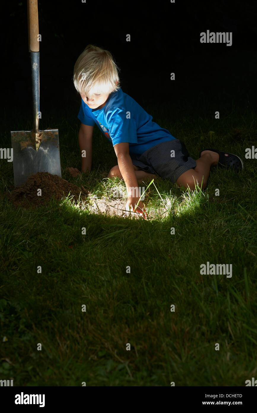 Child boy digging treasure in hi-res stock photography and images - Alamy