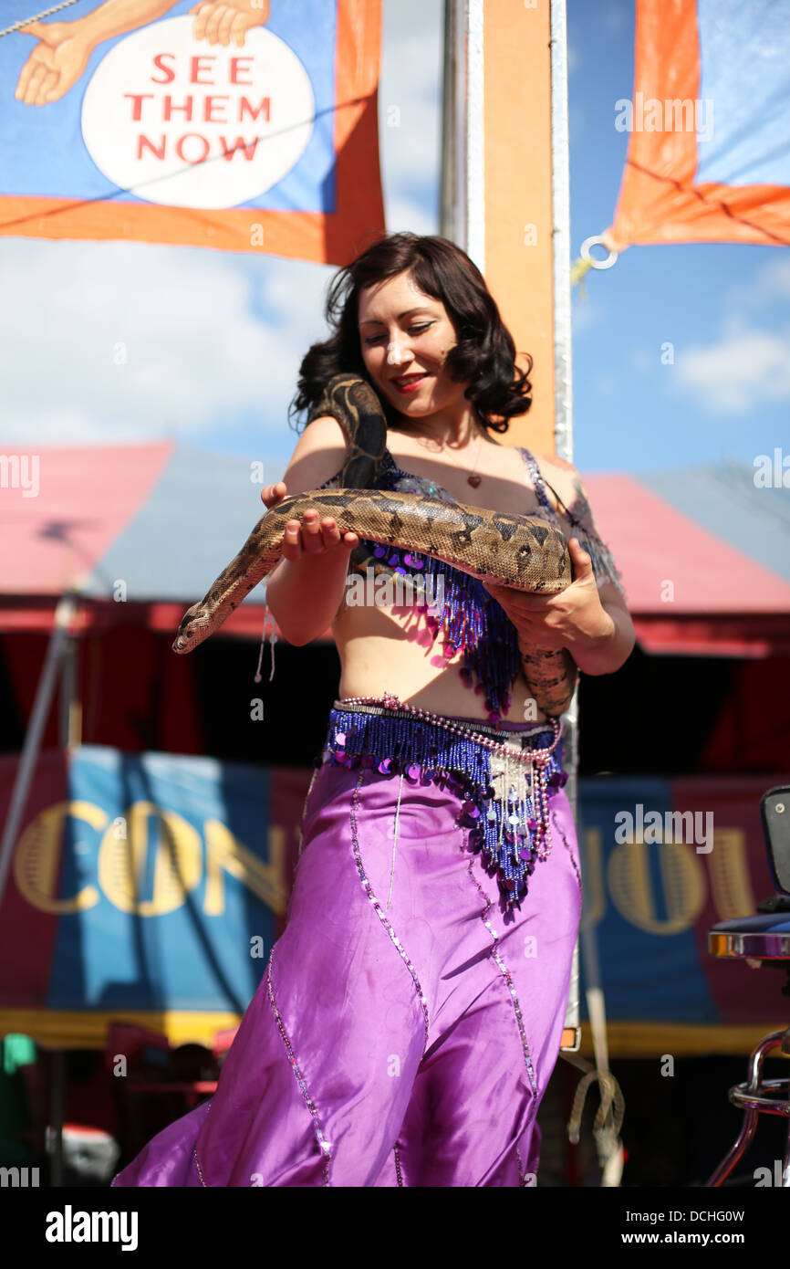 A snake charmer woman at a carnival act at the Steele County Fair in ...