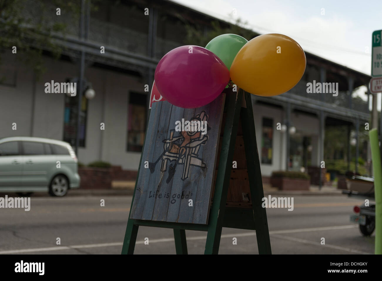 Balloons attached to a life is good sign outside a storefront within ...