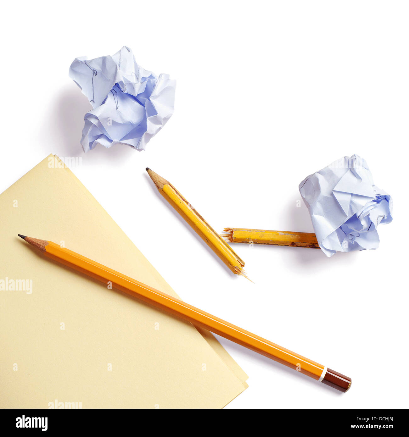 Note paper, crumpled paper, pencil and a broken pencil on white Stock ...
