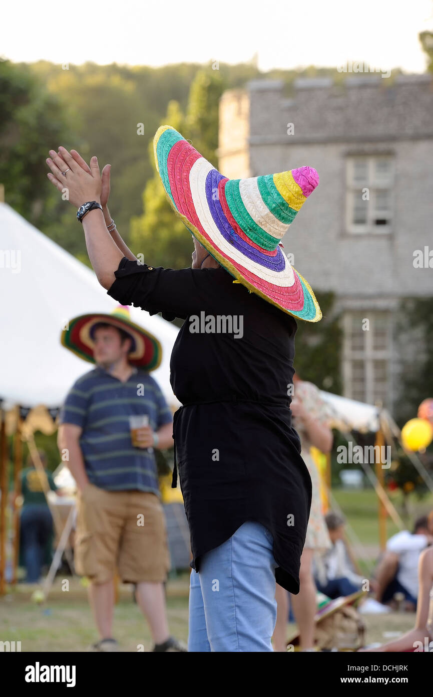Woman at outside summer festival dancing and clapping her hands to the ...
