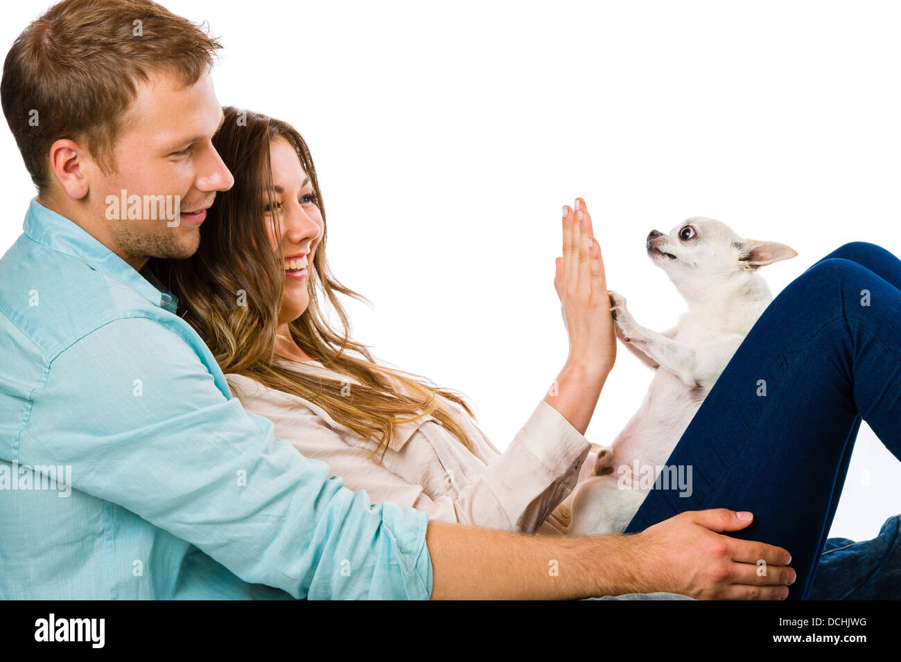 Lovely attractive couple and dog together, studio shot, white ...