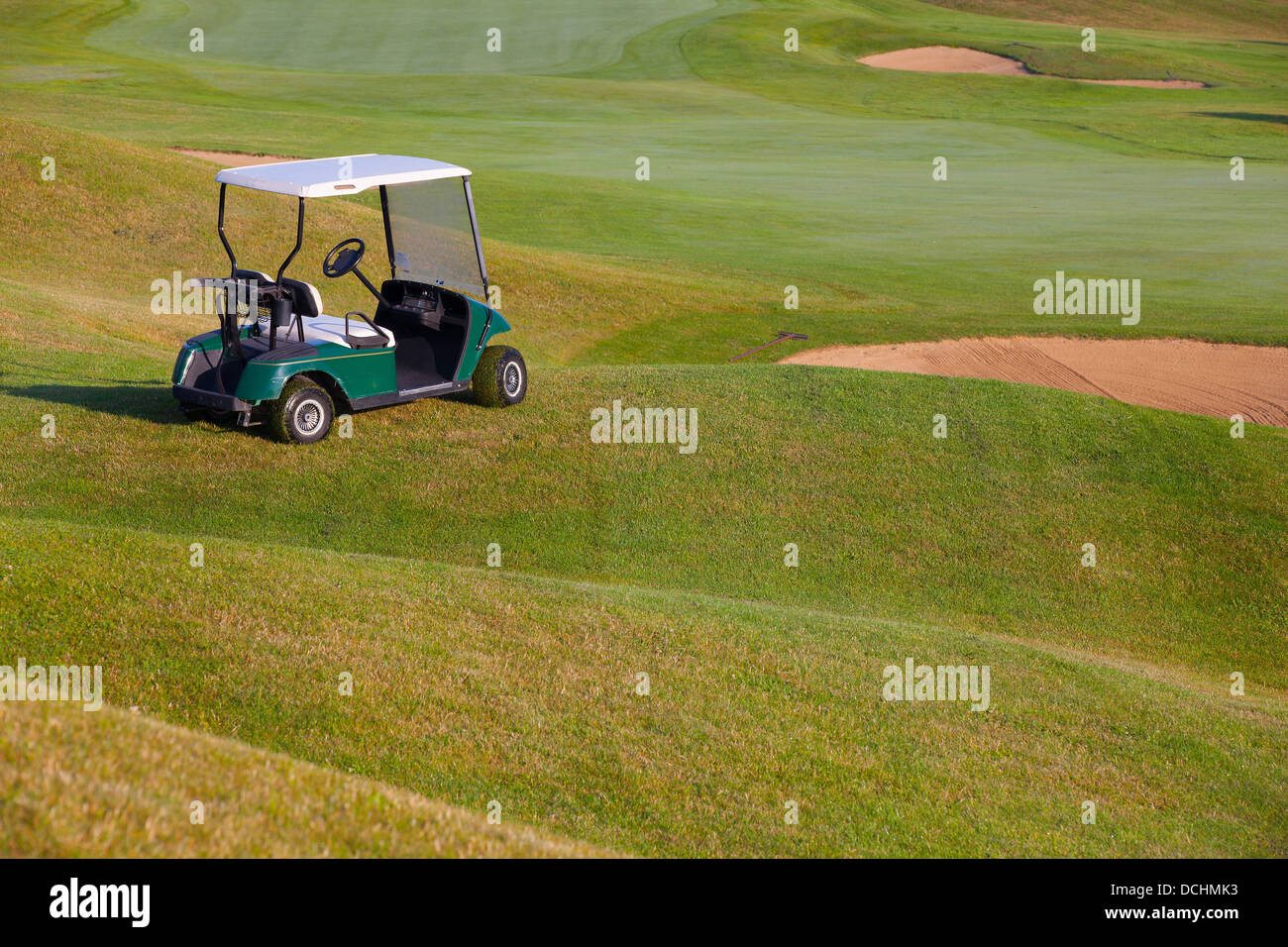 Great view at the beautiful golf course with the green golf cart Stock ...