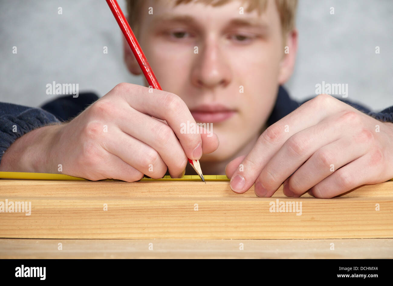Worker measures distance and puts a mark Stock Photo - Alamy