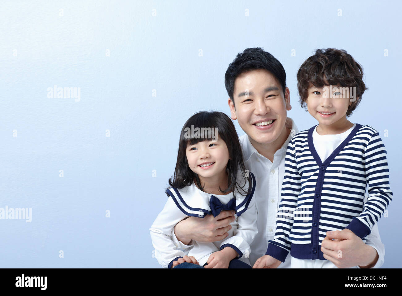 father hugging kids Stock Photo - Alamy