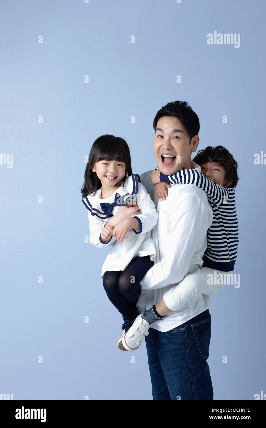 father carrying his kids Stock Photo - Alamy