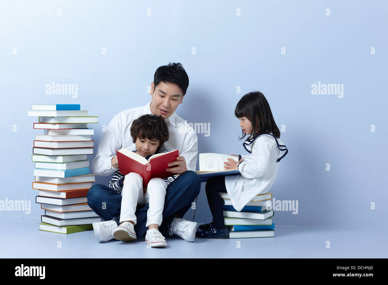a father reading books with his kids Stock Photo - Alamy