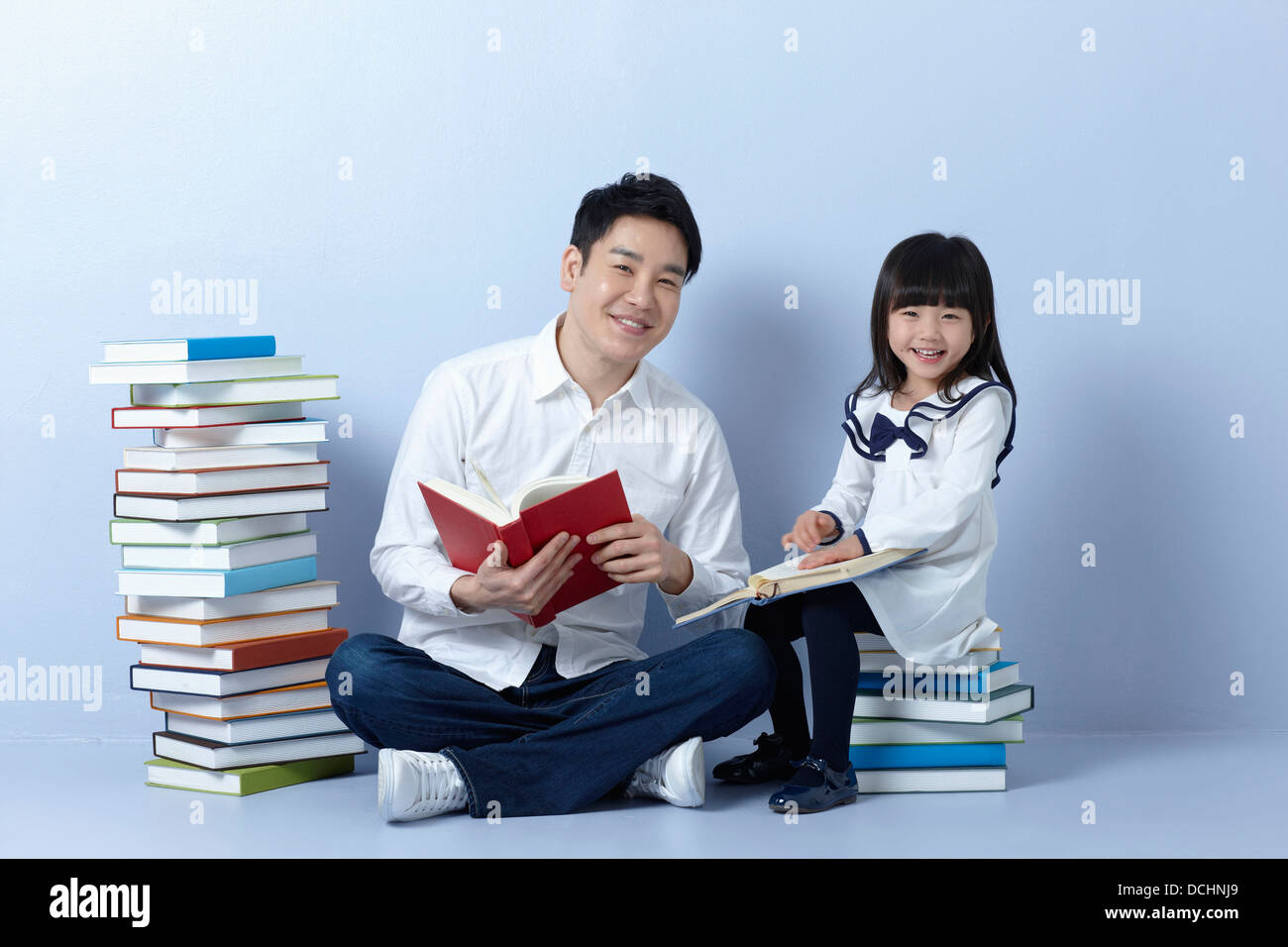 a father reading books with his daughter Stock Photo - Alamy