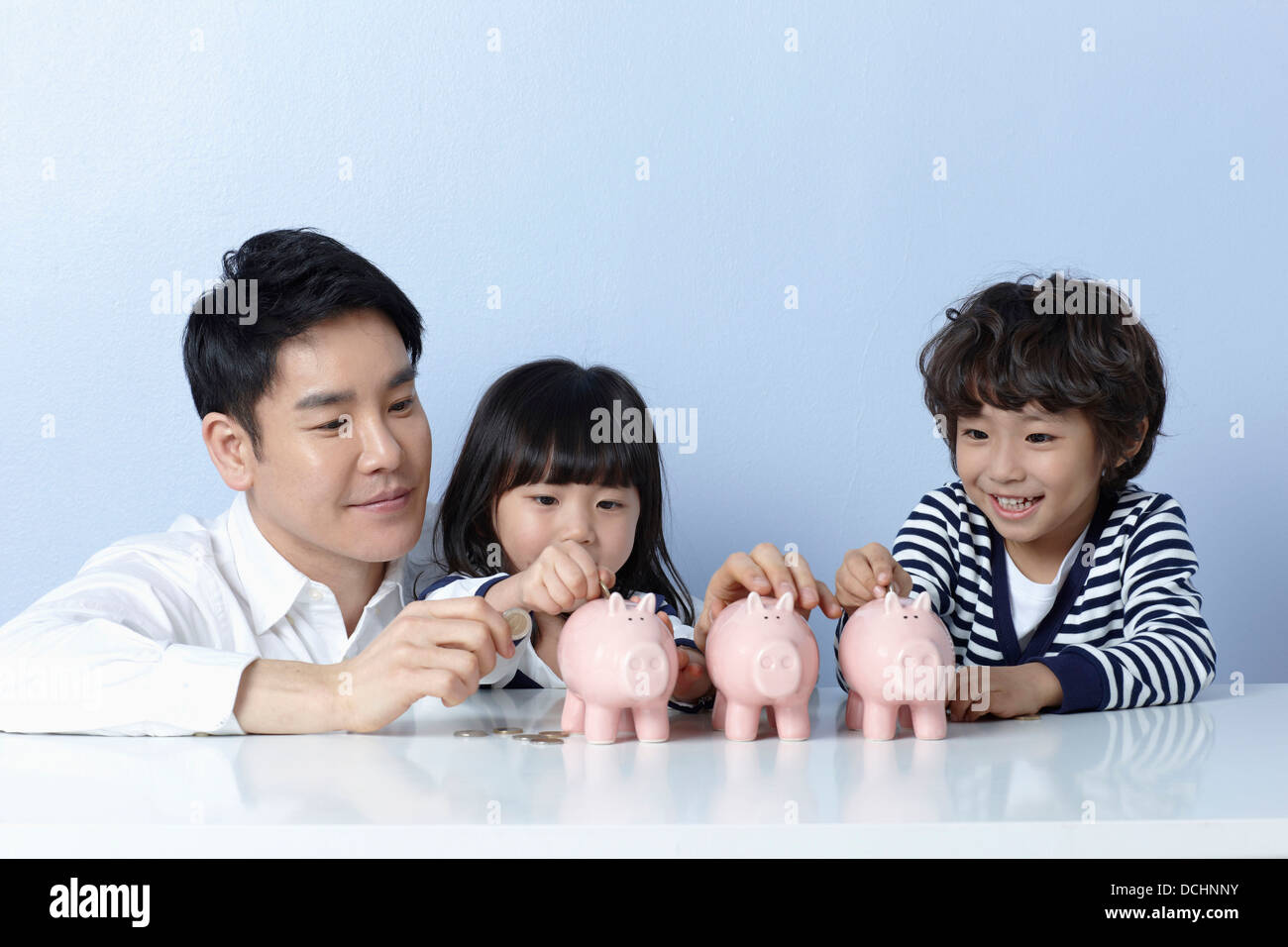 a father helping kids to save money Stock Photo - Alamy