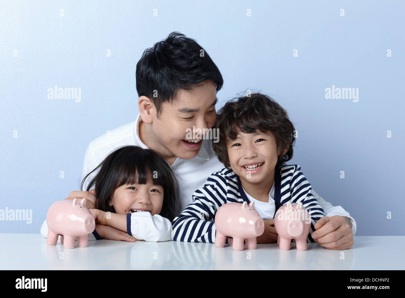 a father helping kids to save money Stock Photo - Alamy