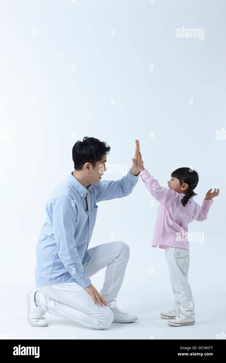 a father and a daughter doing high five Stock Photo - Alamy