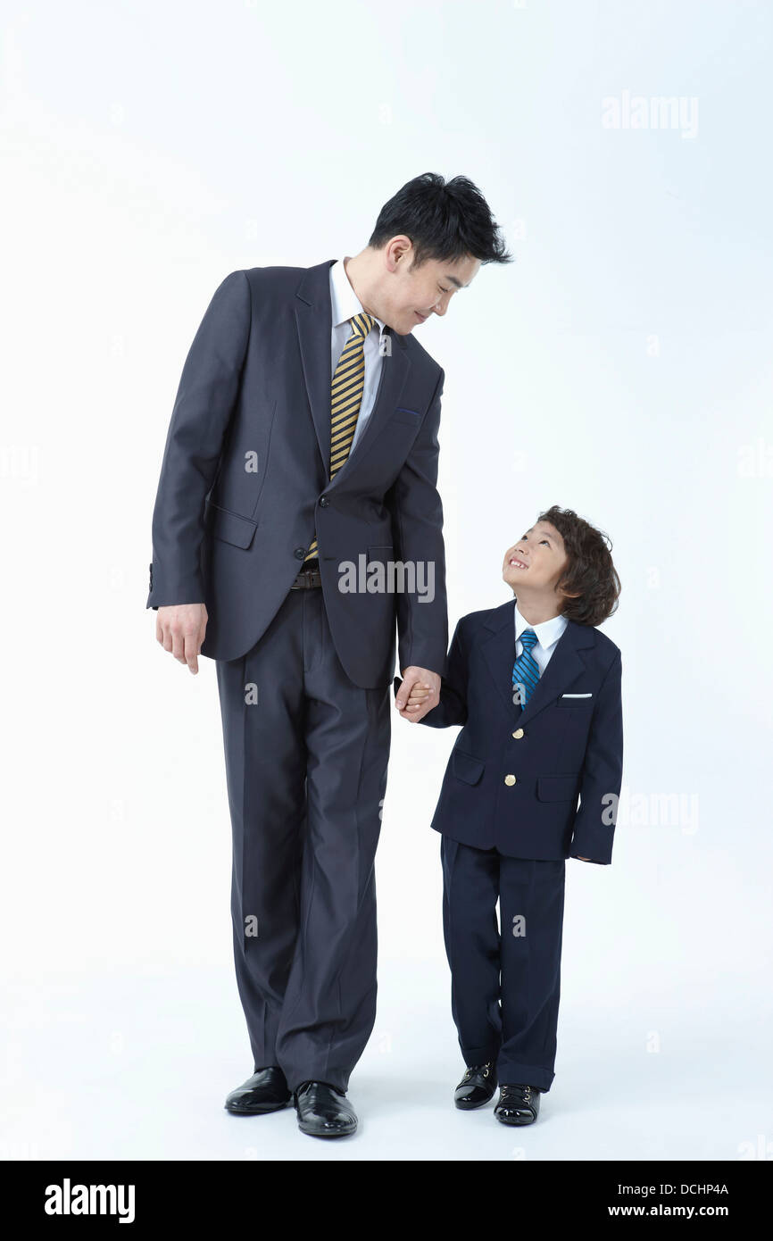 a boy dressed up as a business man with his father Stock Photo - Alamy