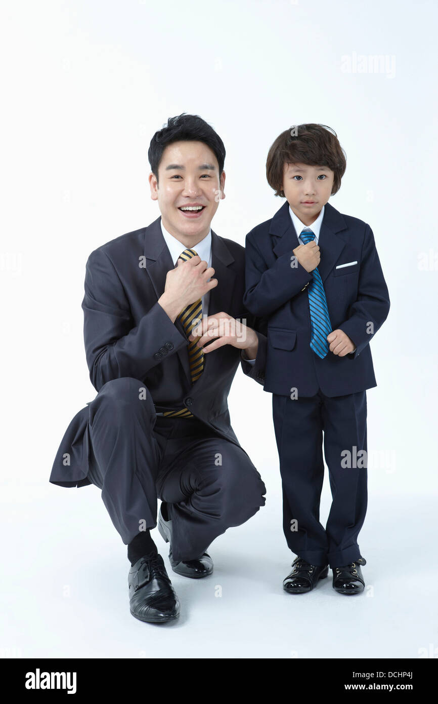 a boy dressed up as a business man with his father Stock Photo - Alamy