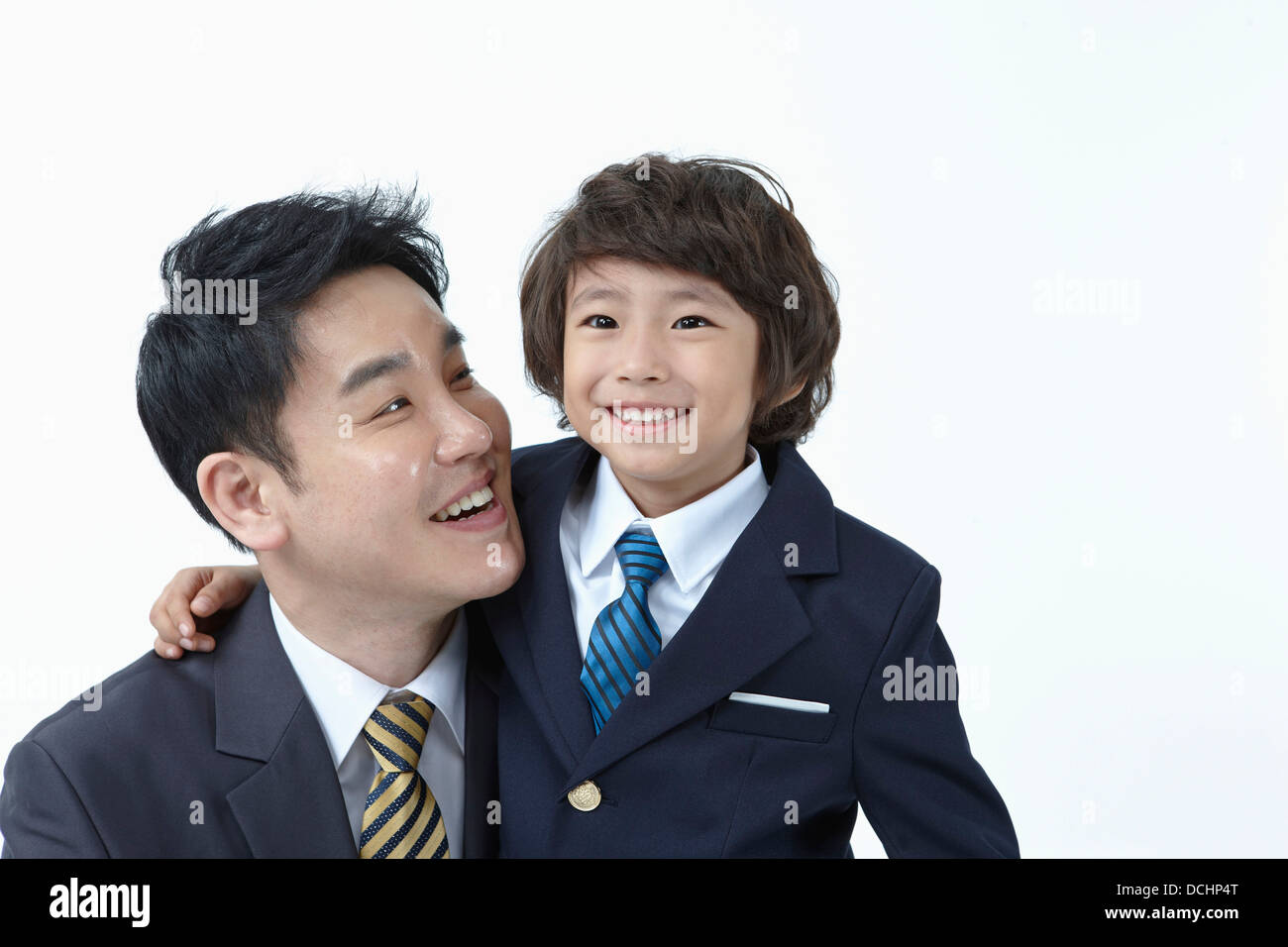 a boy dressed up as a business man with his father Stock Photo - Alamy