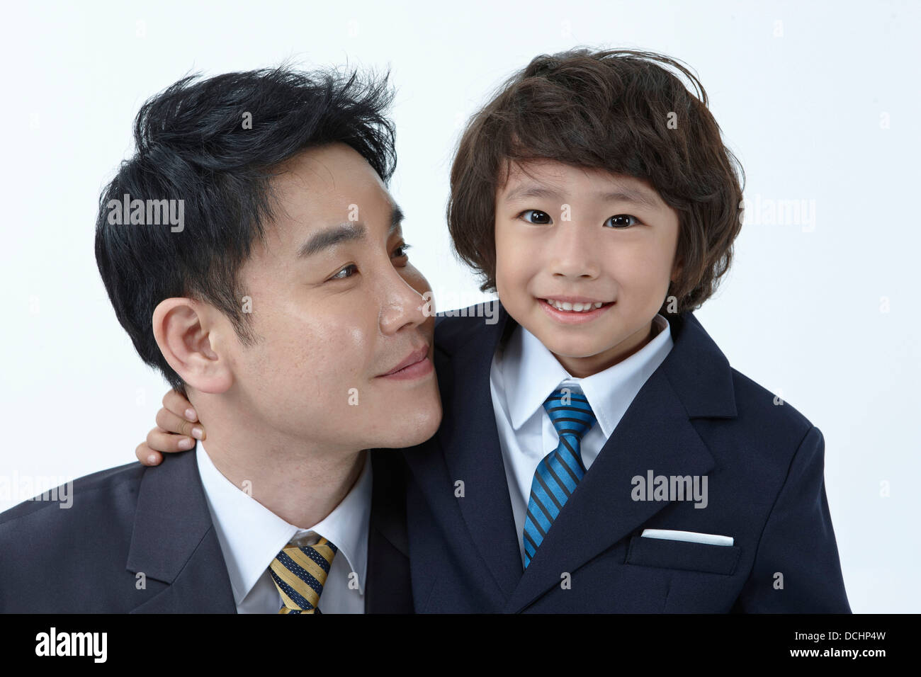 a boy dressed up as a business man with his father Stock Photo - Alamy