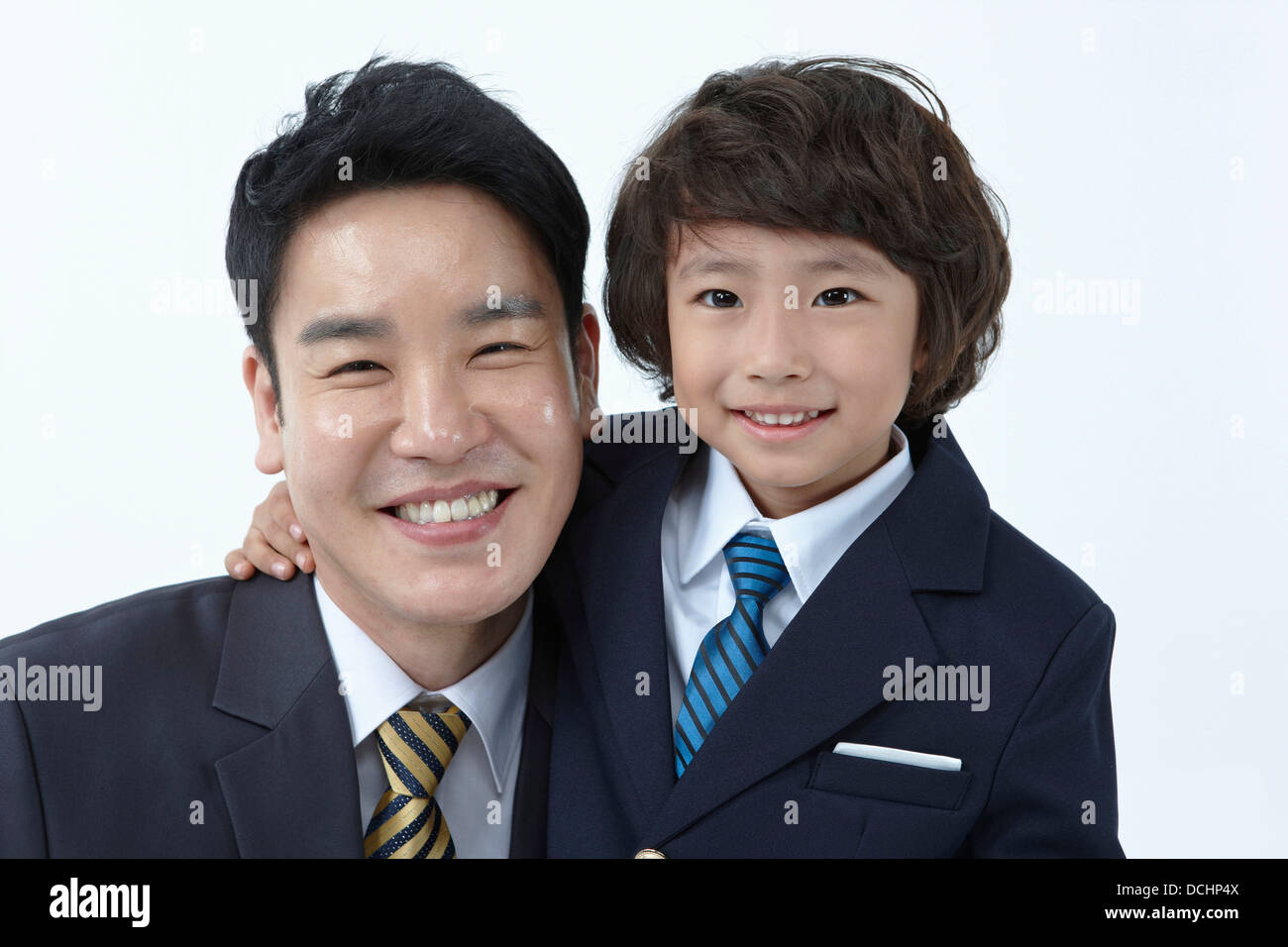 a boy dressed up as a business man with his father Stock Photo - Alamy