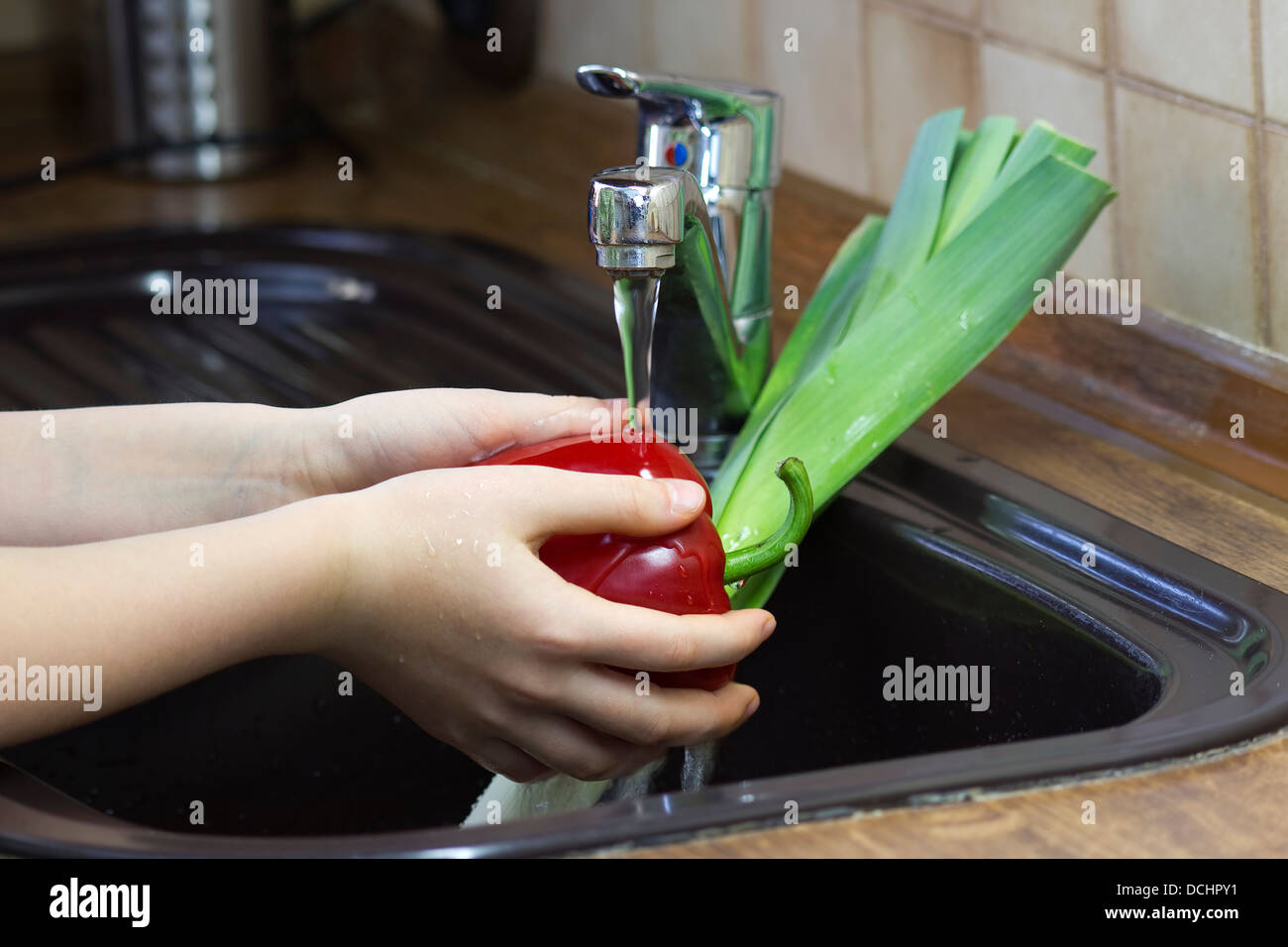 Child wash vegetables sink hi-res stock photography and images - Alamy