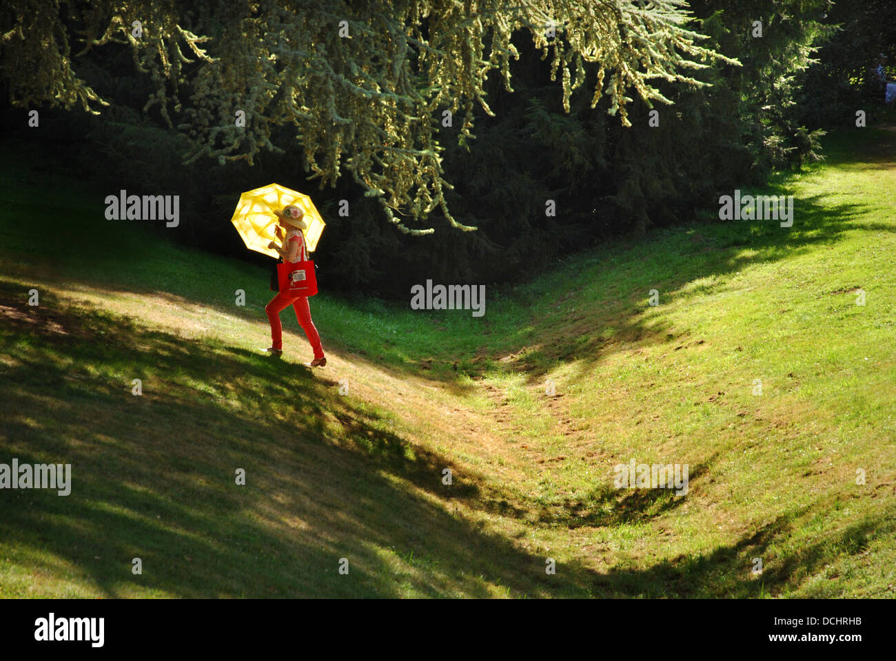 woman in red walking uphill at Dyck castle gardens Germany Stock Photo ...