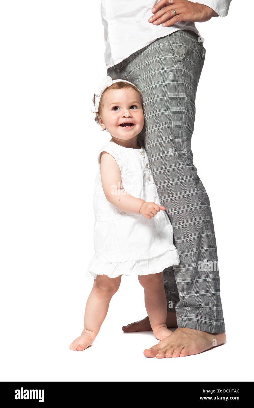 Happy baby at fathers legs Stock Photo - Alamy