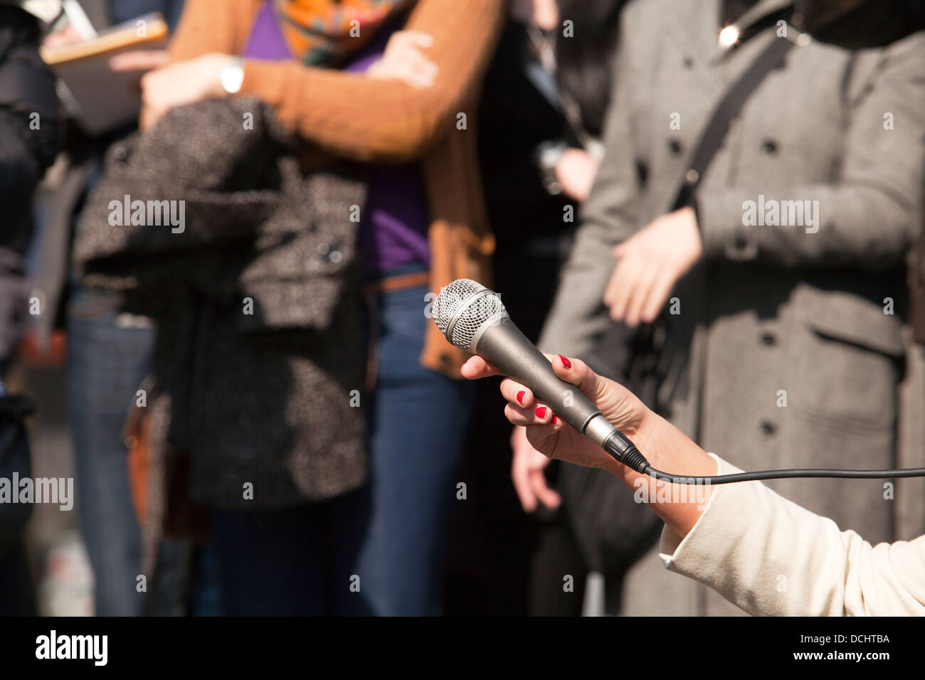A journalist is making a interview with a microphone Stock Photo - Alamy
