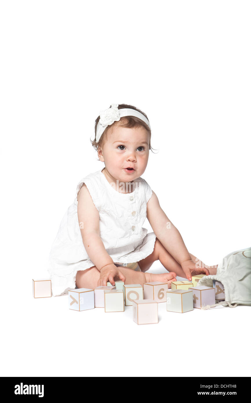 Girl playing with alphabet blocks Stock Photo - Alamy