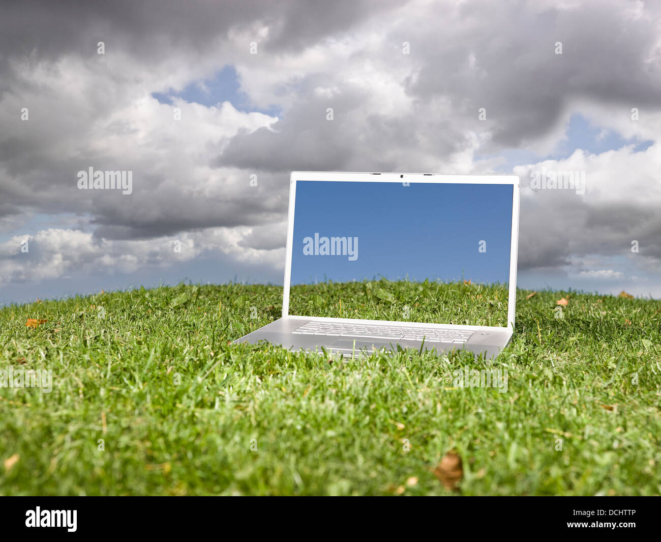Laptop outdoors on a green field Stock Photo - Alamy