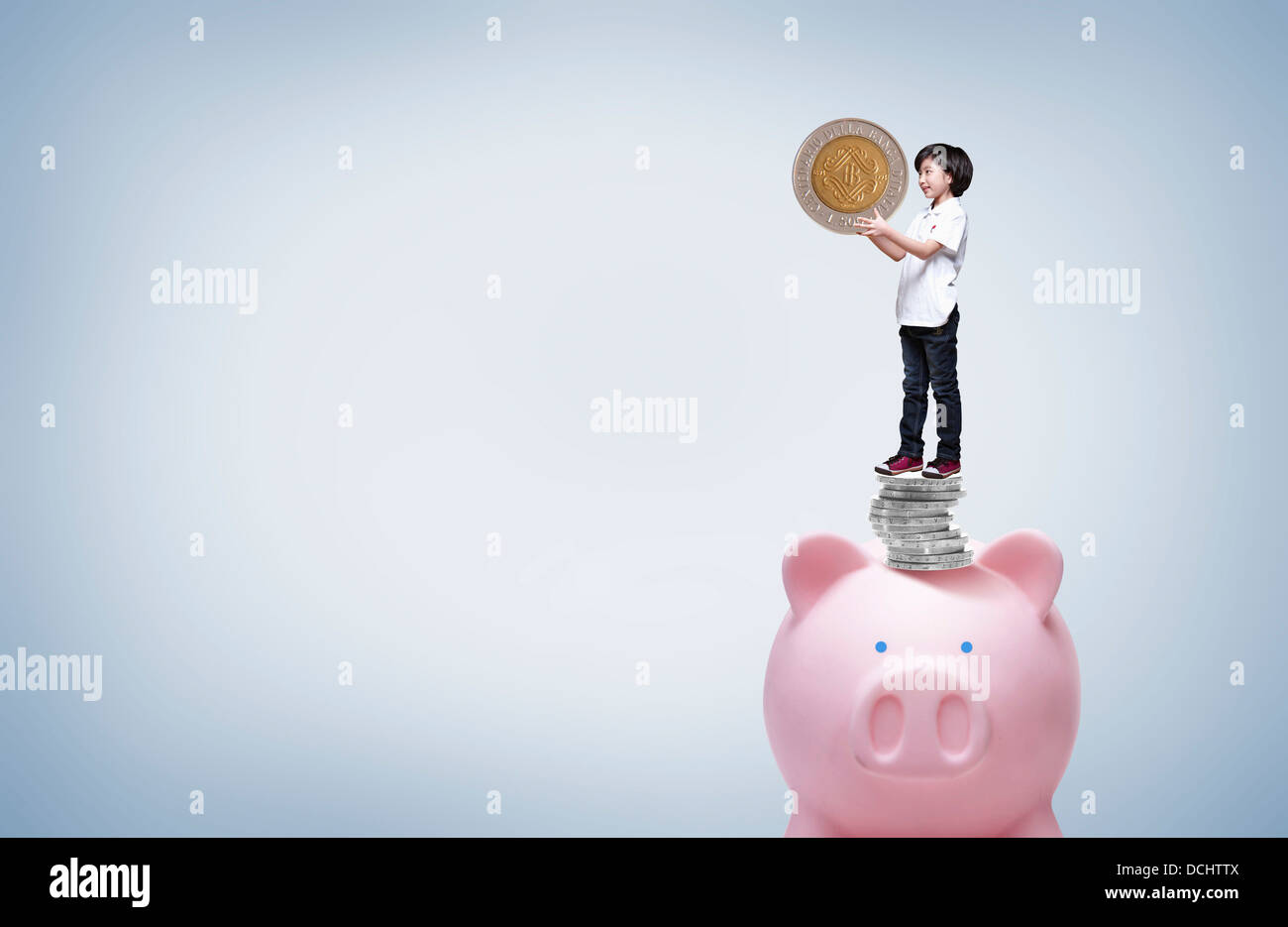 a boy holding a coin Stock Photo - Alamy