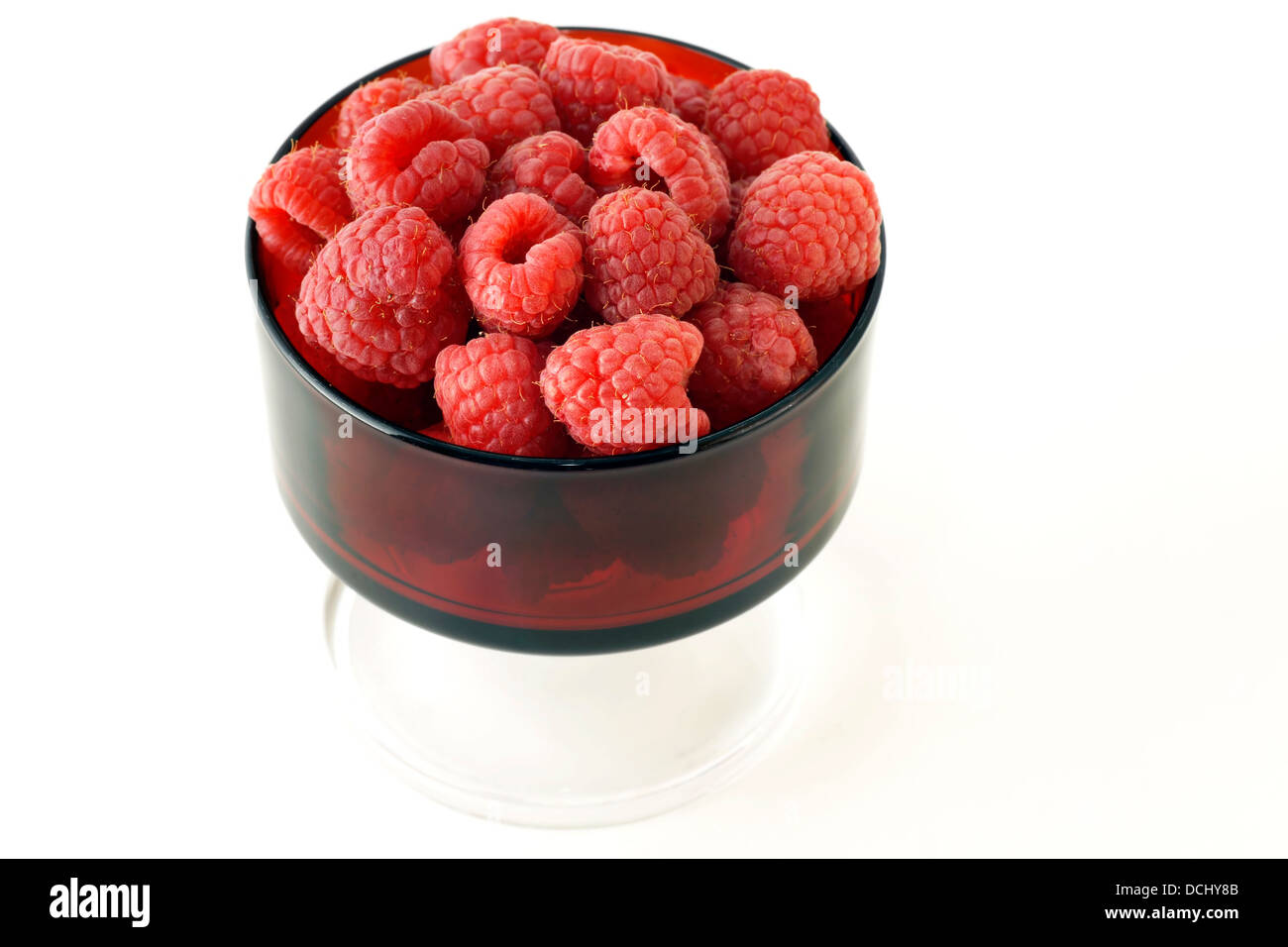 Glass filled with raspberries Stock Photo - Alamy