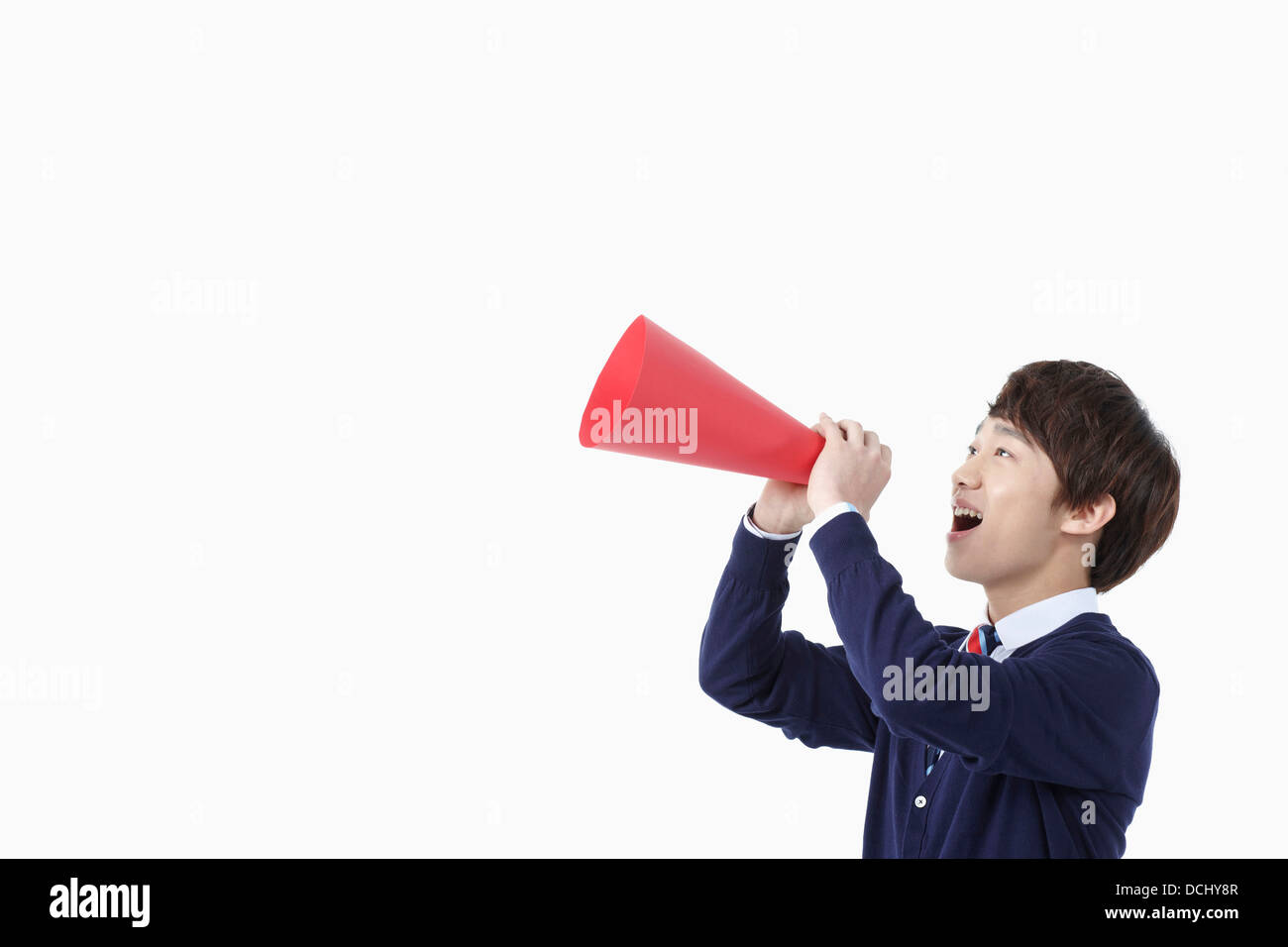 a boy in school uniform with a paper megaphone Stock Photo - Alamy