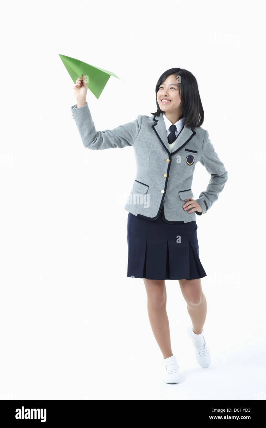 a girl in a school uniform and a paper plane Stock Photo - Alamy