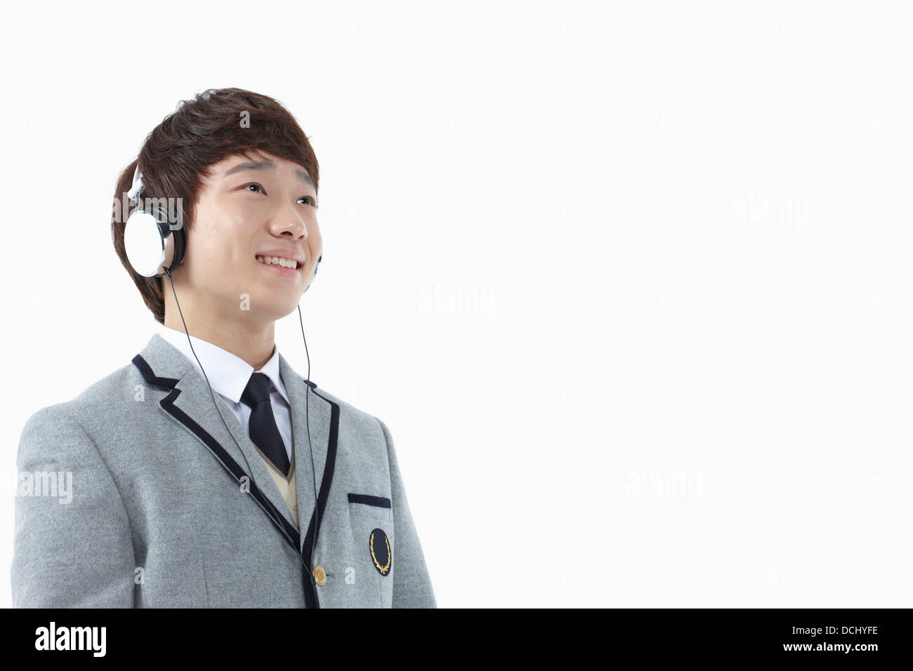 a boy in a school uniform wearing a head set Stock Photo - Alamy