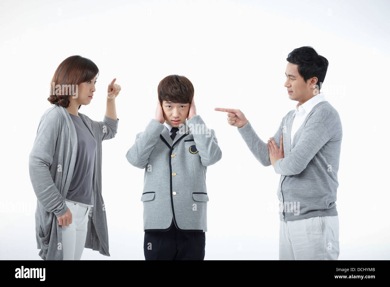 parents scolding at a son with a school uniform Stock Photo - Alamy
