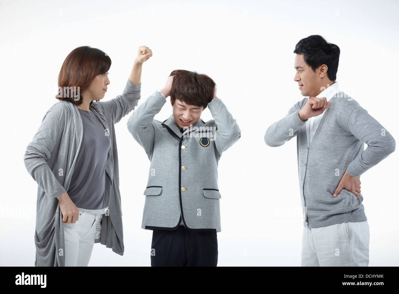 parents scolding at a son with a school uniform Stock Photo - Alamy