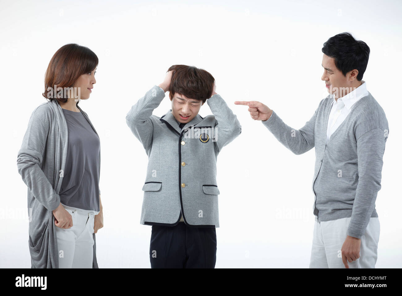 parents scolding at a son with a school uniform Stock Photo - Alamy