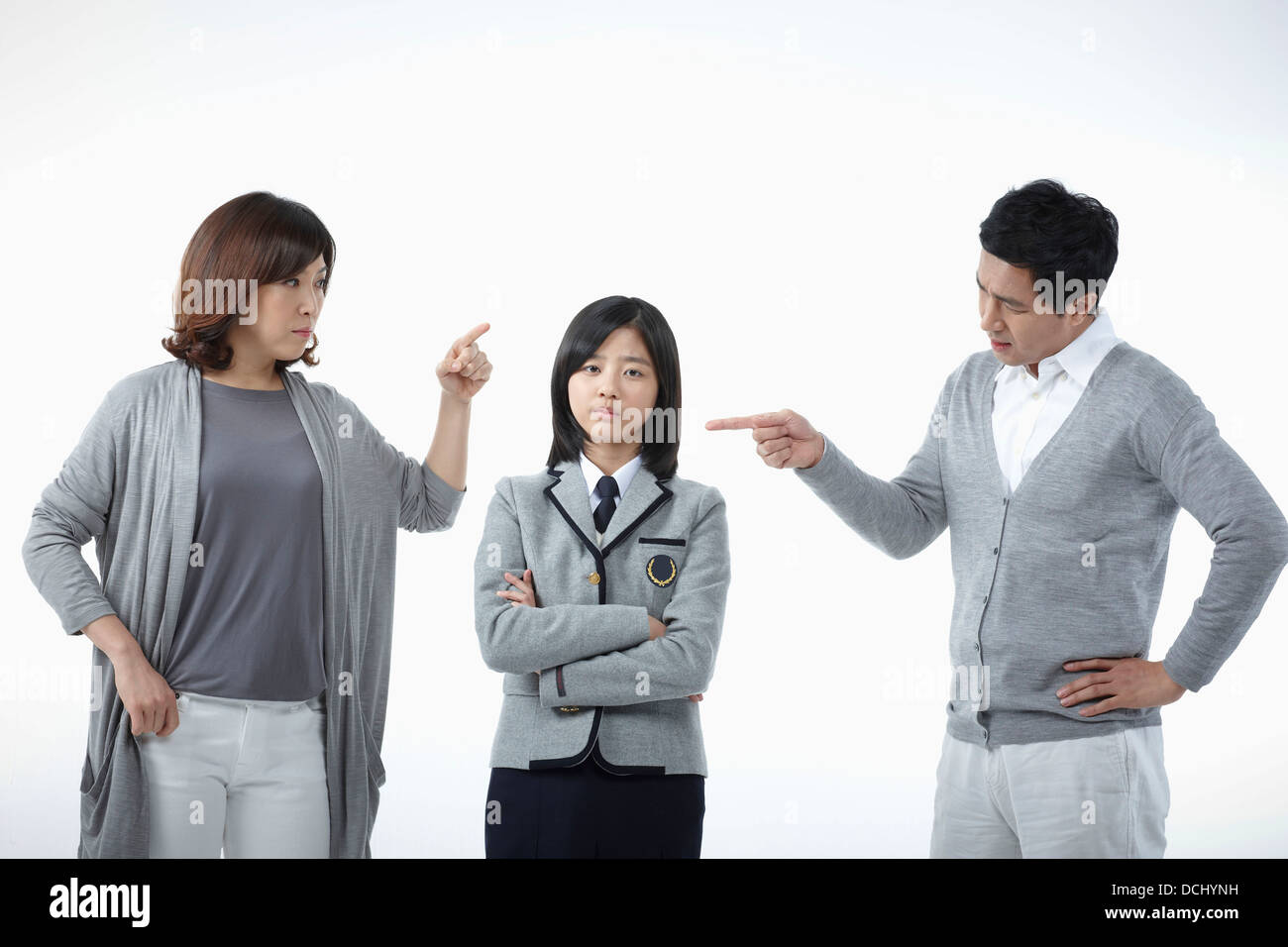 parents scolding at a daughter with a school uniform Stock Photo - Alamy