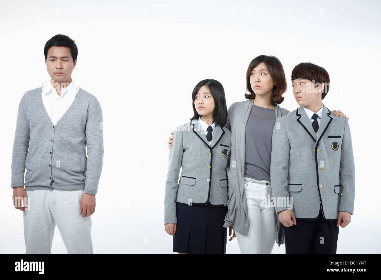 parents next to children with school uniforms Stock Photo - Alamy