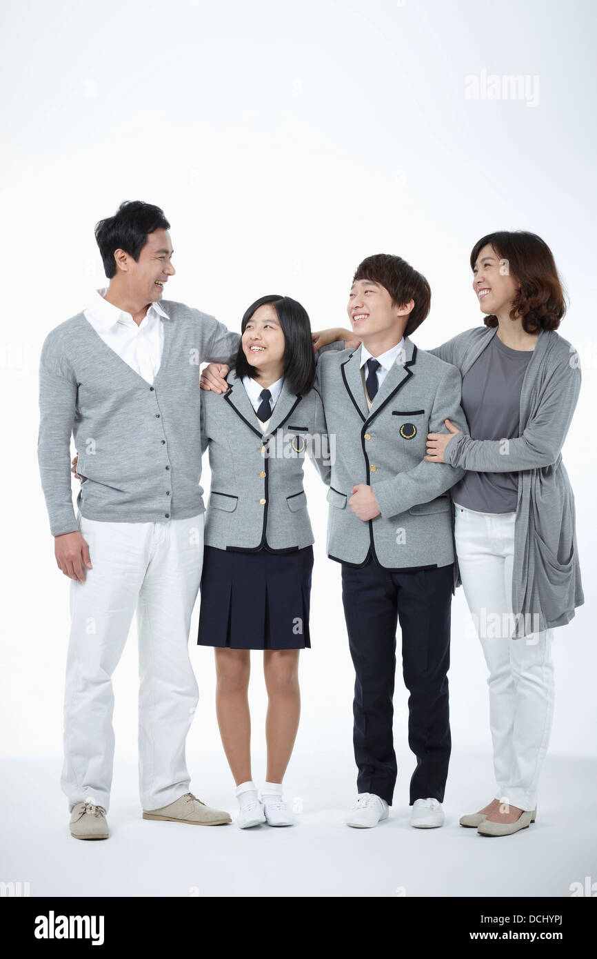 parents next to children with school uniforms Stock Photo - Alamy