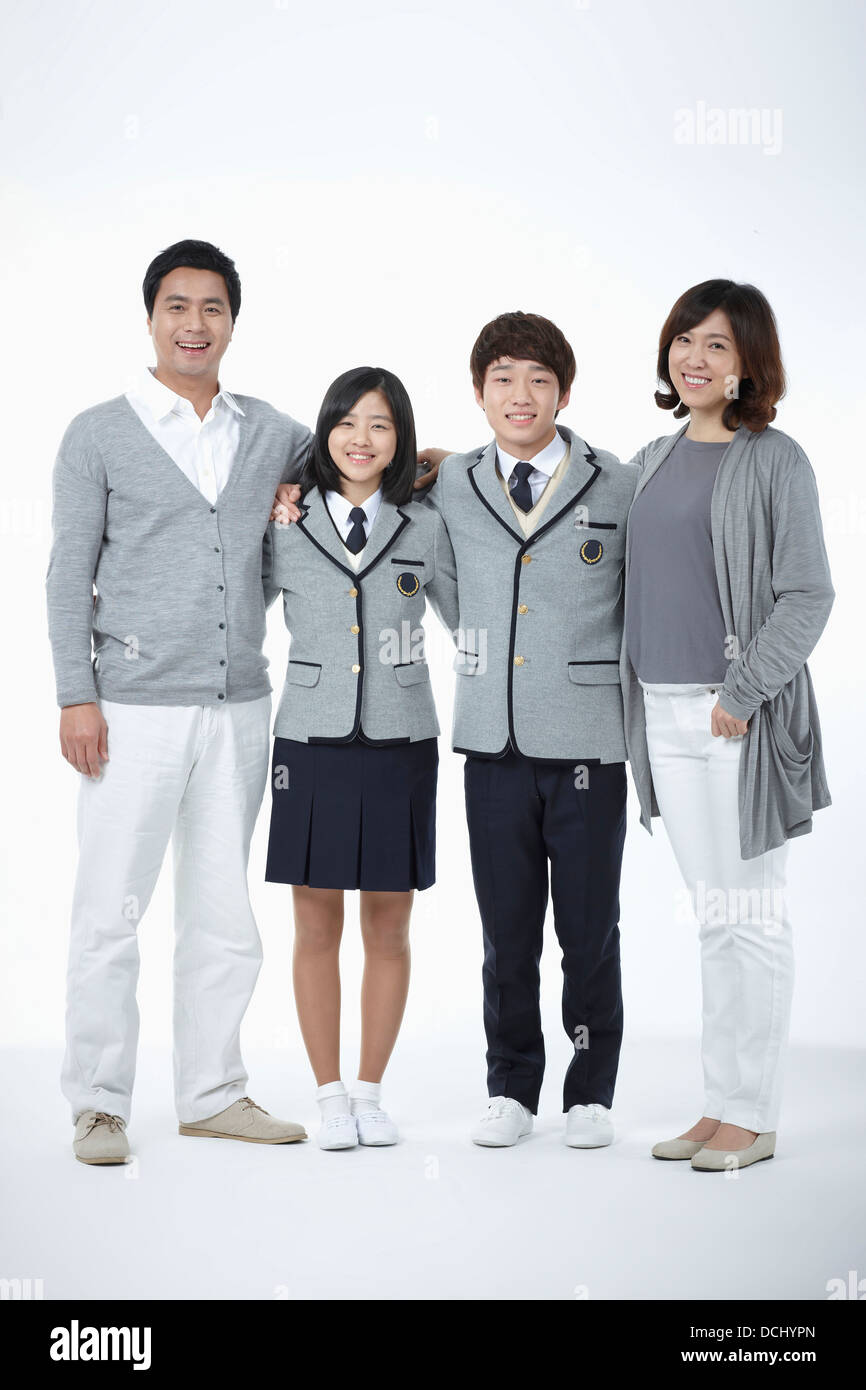 parents next to children with school uniforms Stock Photo - Alamy